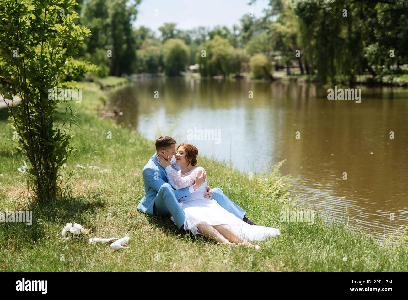 bride in a light wedding dress to the groom in a blue suit Stock Photo ...