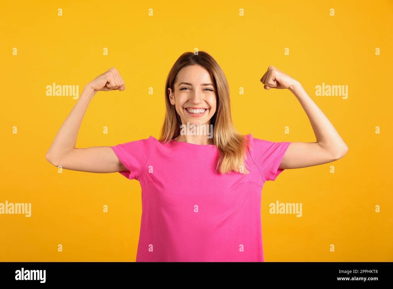 Strong woman as symbol of girl power on yellow background. 8 March ...