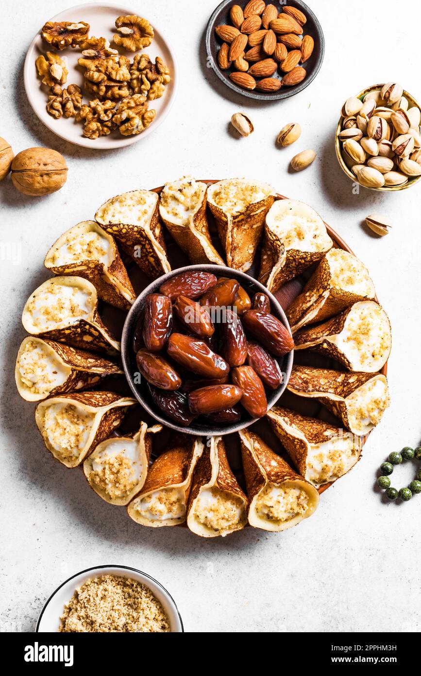 Middle eastern arabian iftar dessert qatayef or atayef, a crescent ...