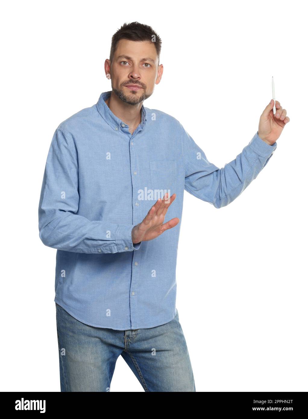 Handsome man pointing at something with pen on white background ...