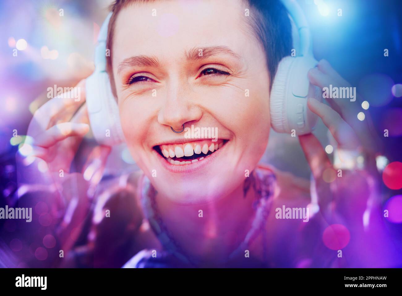 Girl listens to music with white headphones smiling. Disco background ...