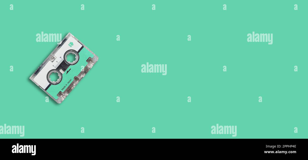 Mini cassette tape on colored background Stock Photo - Alamy