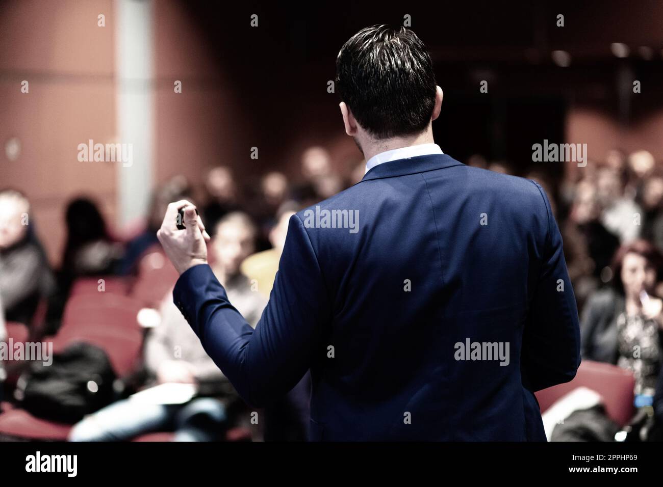 Rear view of speaker giving a talk on corporate Business Conference ...