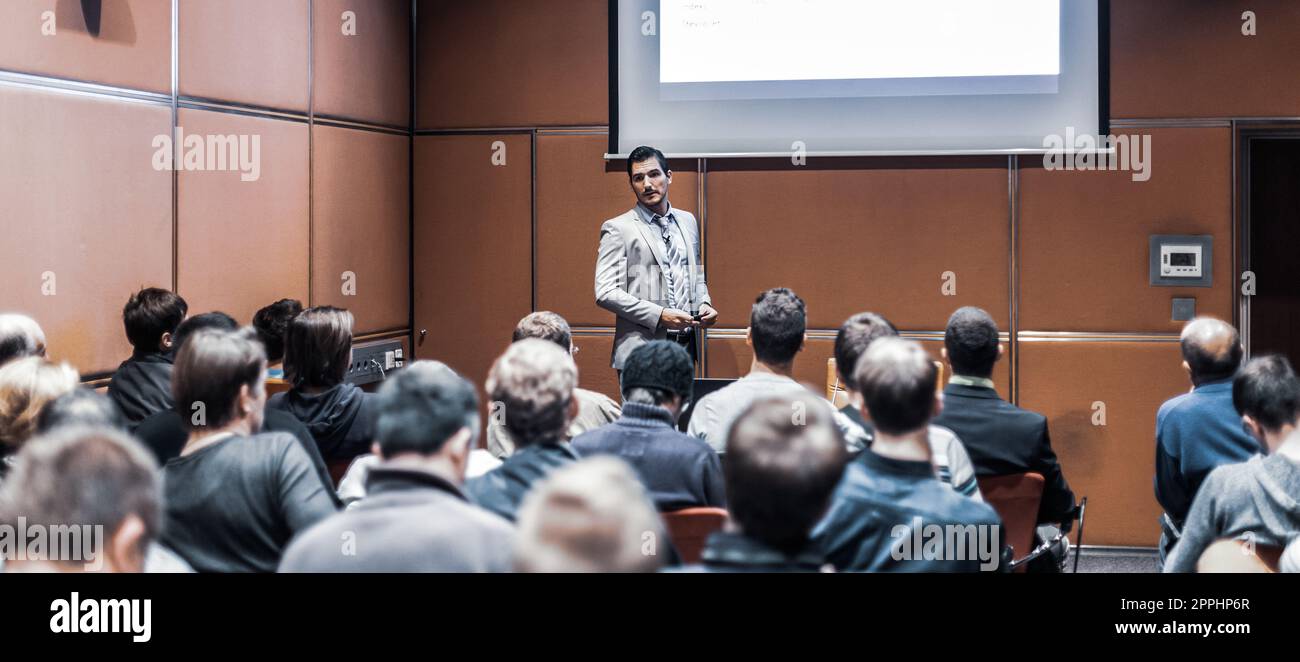 Business speaker giving a talk at business conference meeting event ...