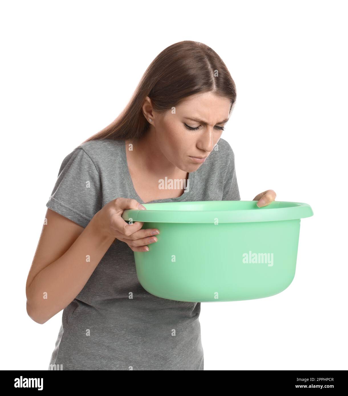 Woman with basin suffering from nausea on white background. Food ...