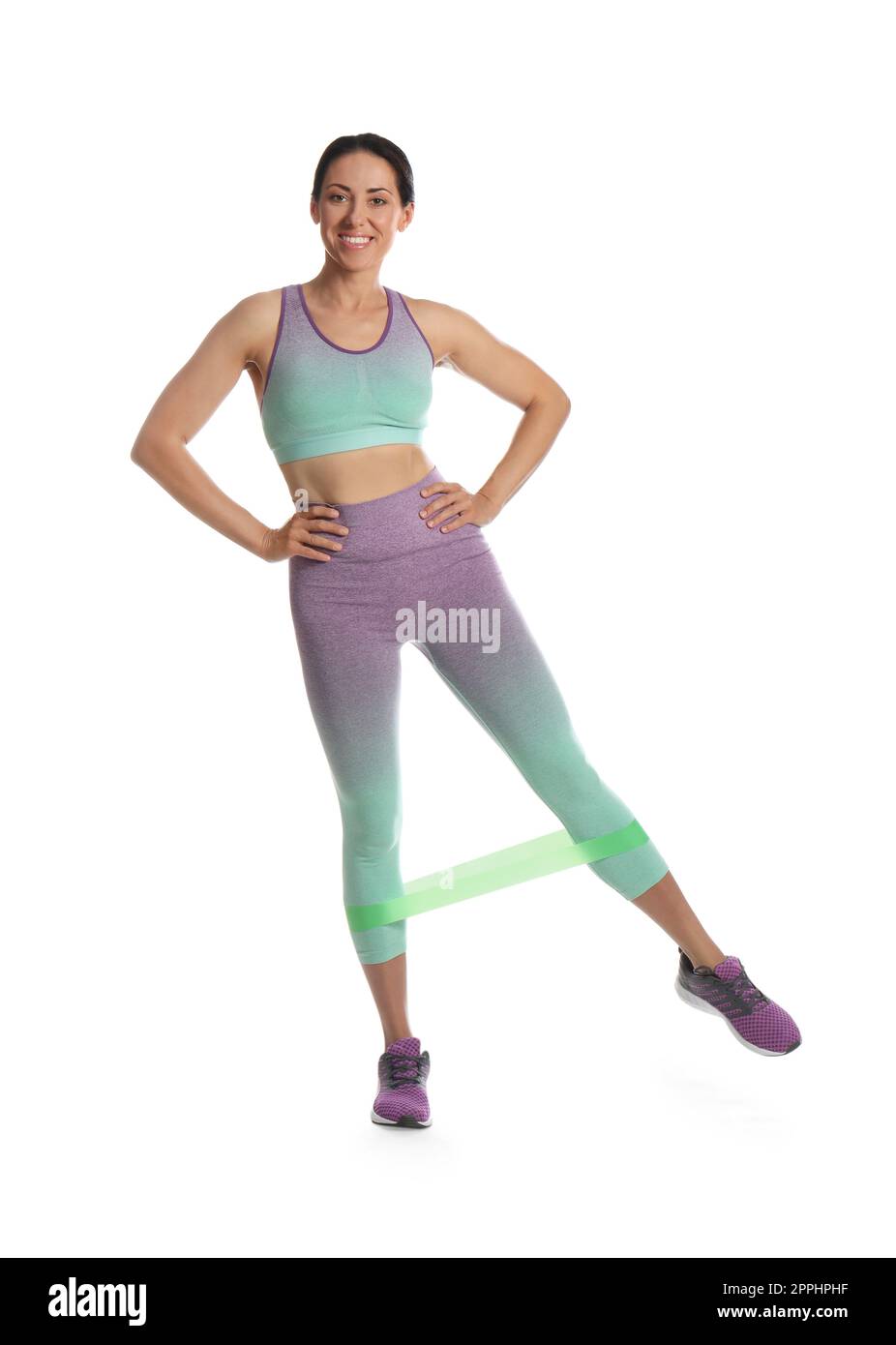 Woman doing sportive exercise with fitness elastic band on white ...