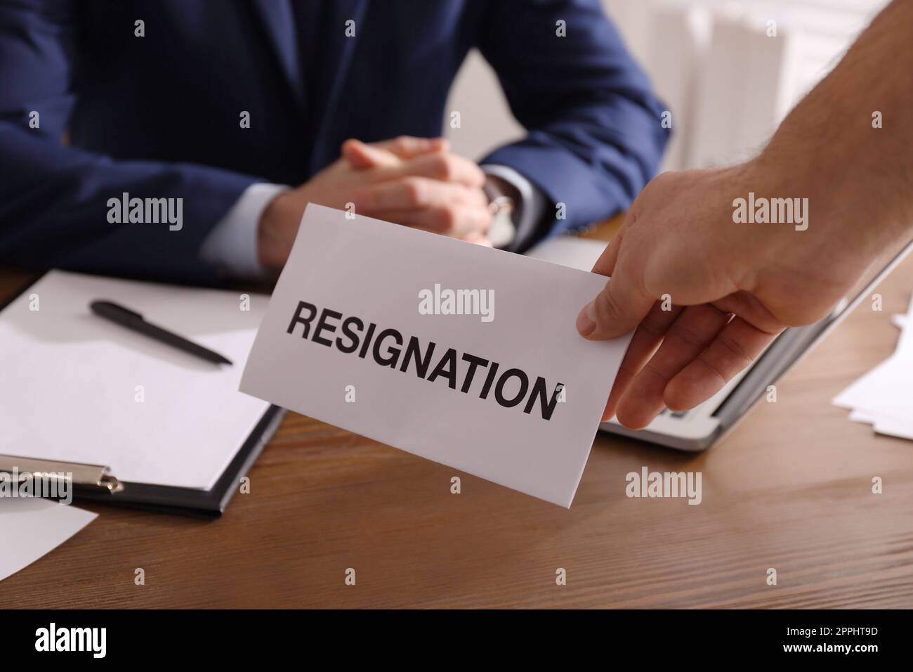 Employee giving resignation letter to boss in office, closeup Stock ...