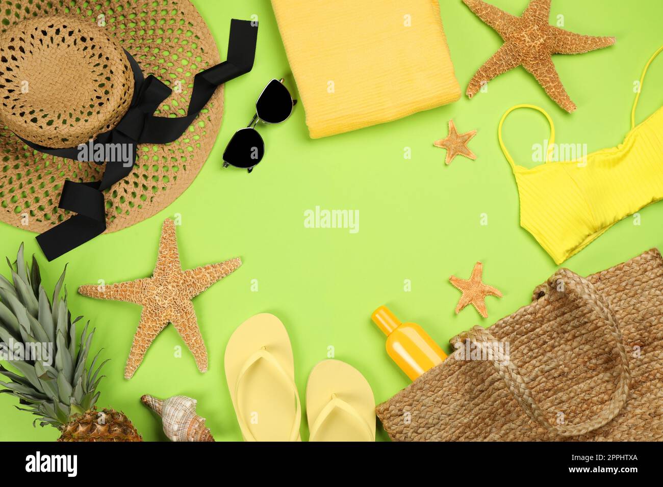 Frame of beach objects on green background, flat lay. Space for text ...