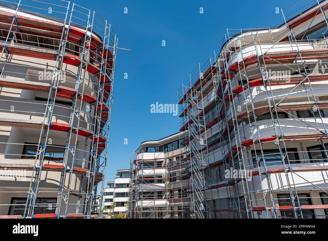 Modern, still scaffolded apartment buildings with bunk houses in a new ...
