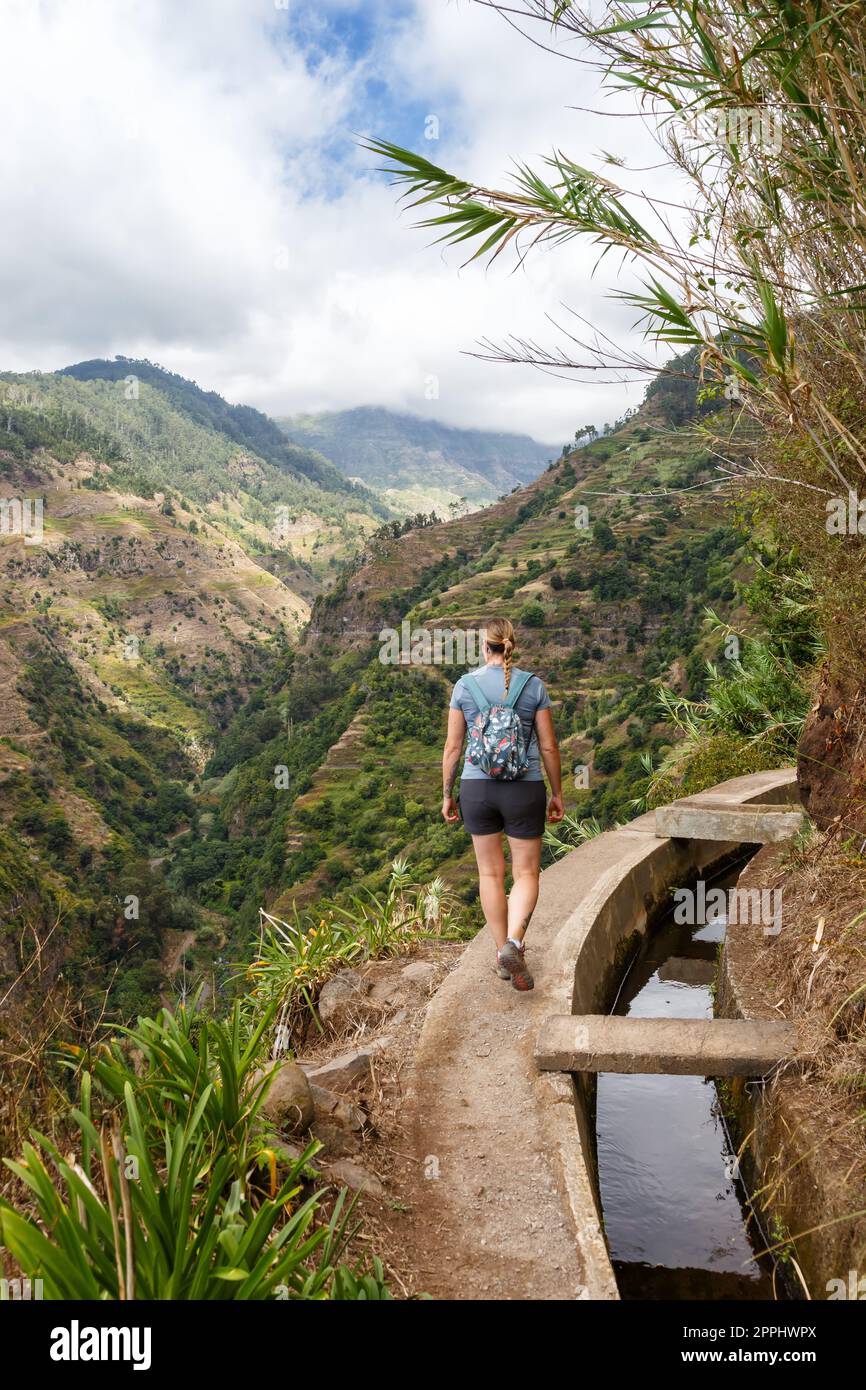 Young woman on hiking trail along Levada Nova portrait format hike tour ...