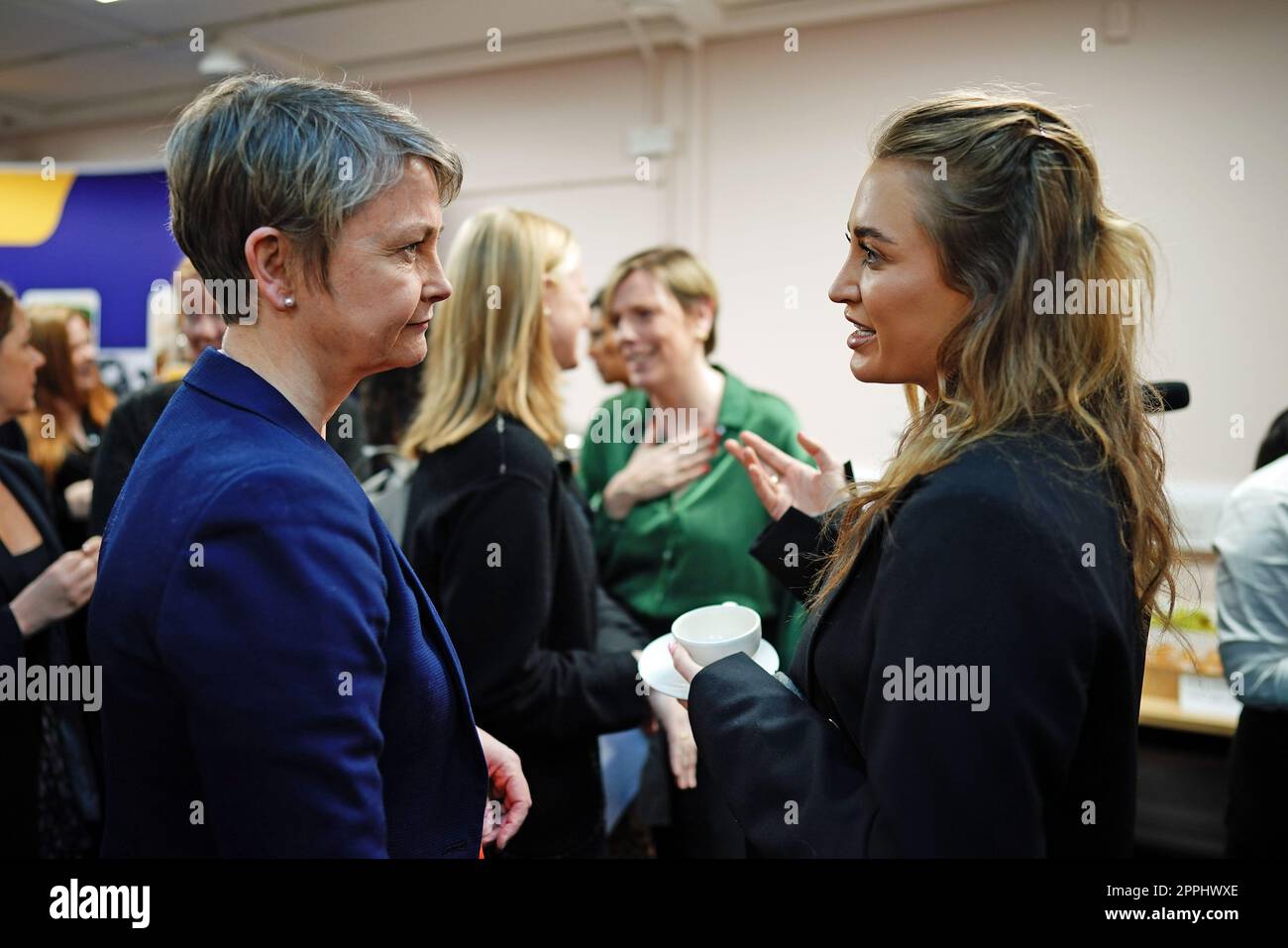 Shadow home secretary Yvette Cooper (left) and Georgia Harrison speak ...