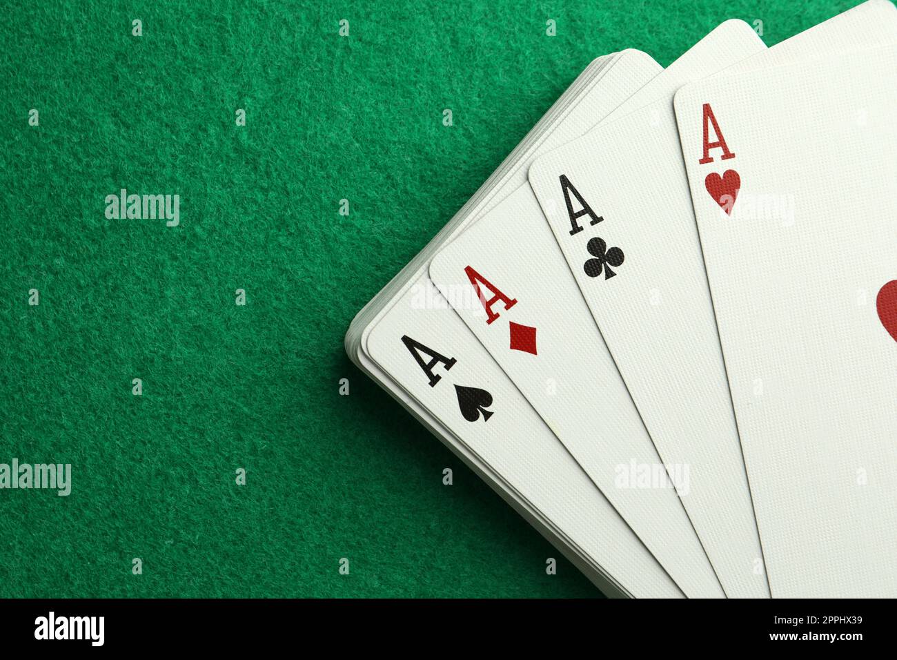 Four aces playing cards on green table, top view. Space for text Stock ...