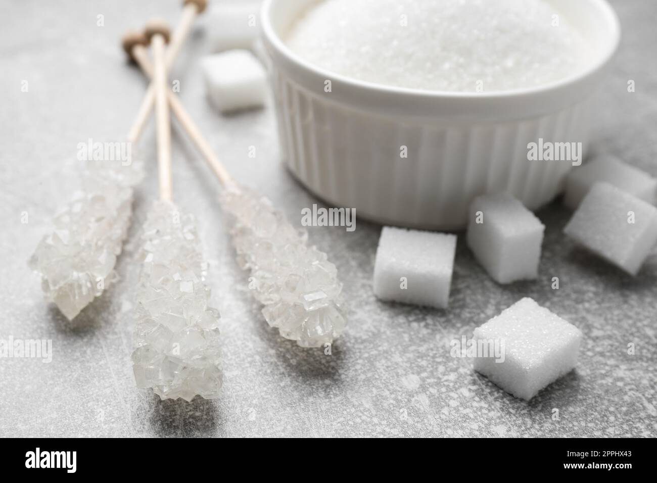 Different types of sugar on light grey table, closeup Stock Photo - Alamy