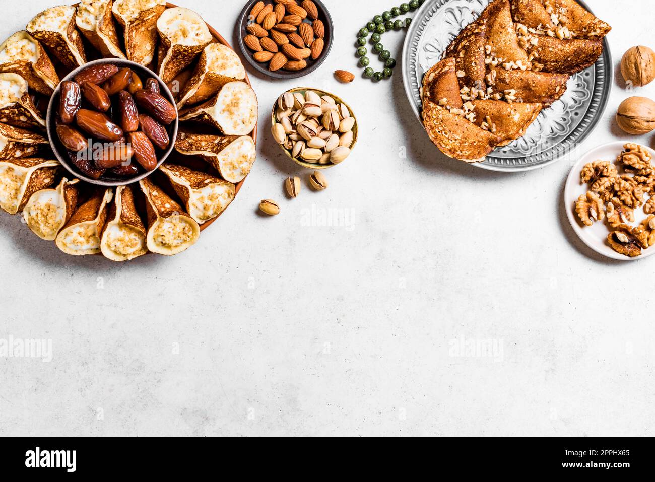 Middle eastern arabian iftar dessert qatayef or atayef, crescent shaped ...