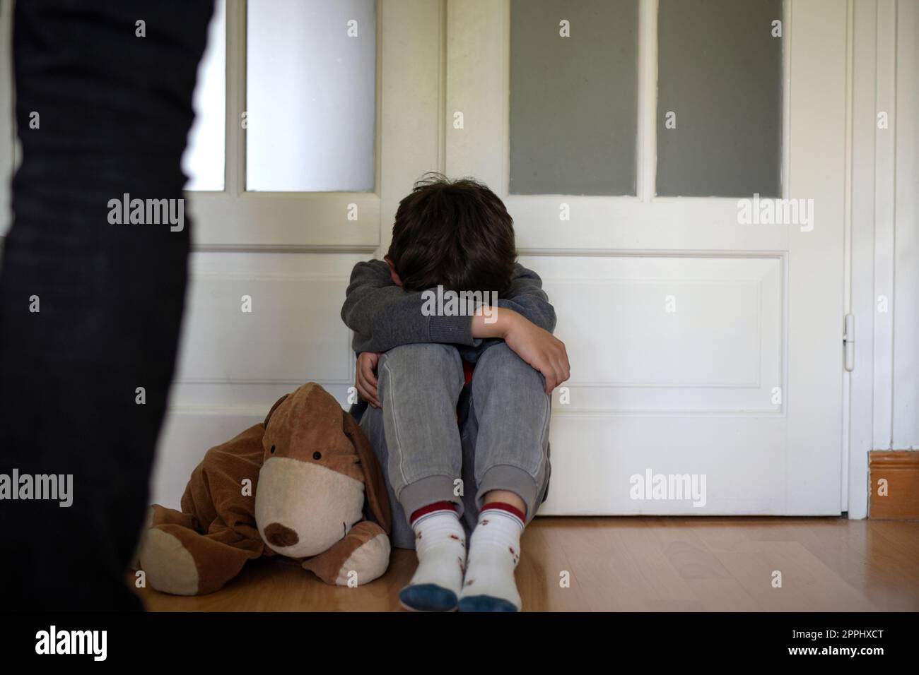 view of a child victim of child abuse in his room Stock Photo - Alamy