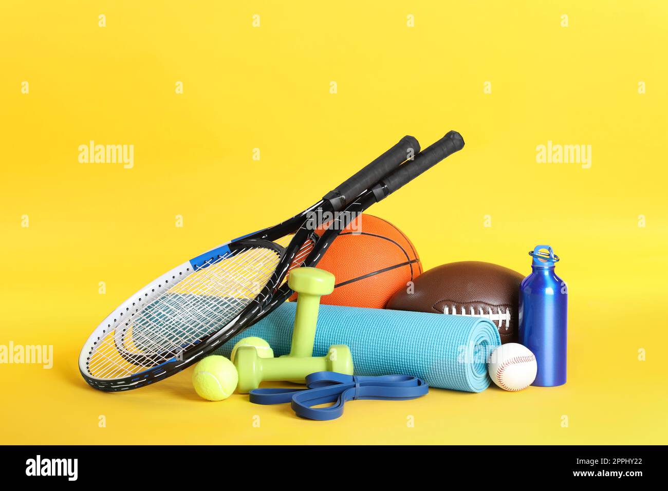 Set of different sports equipment on yellow background Stock Photo - Alamy