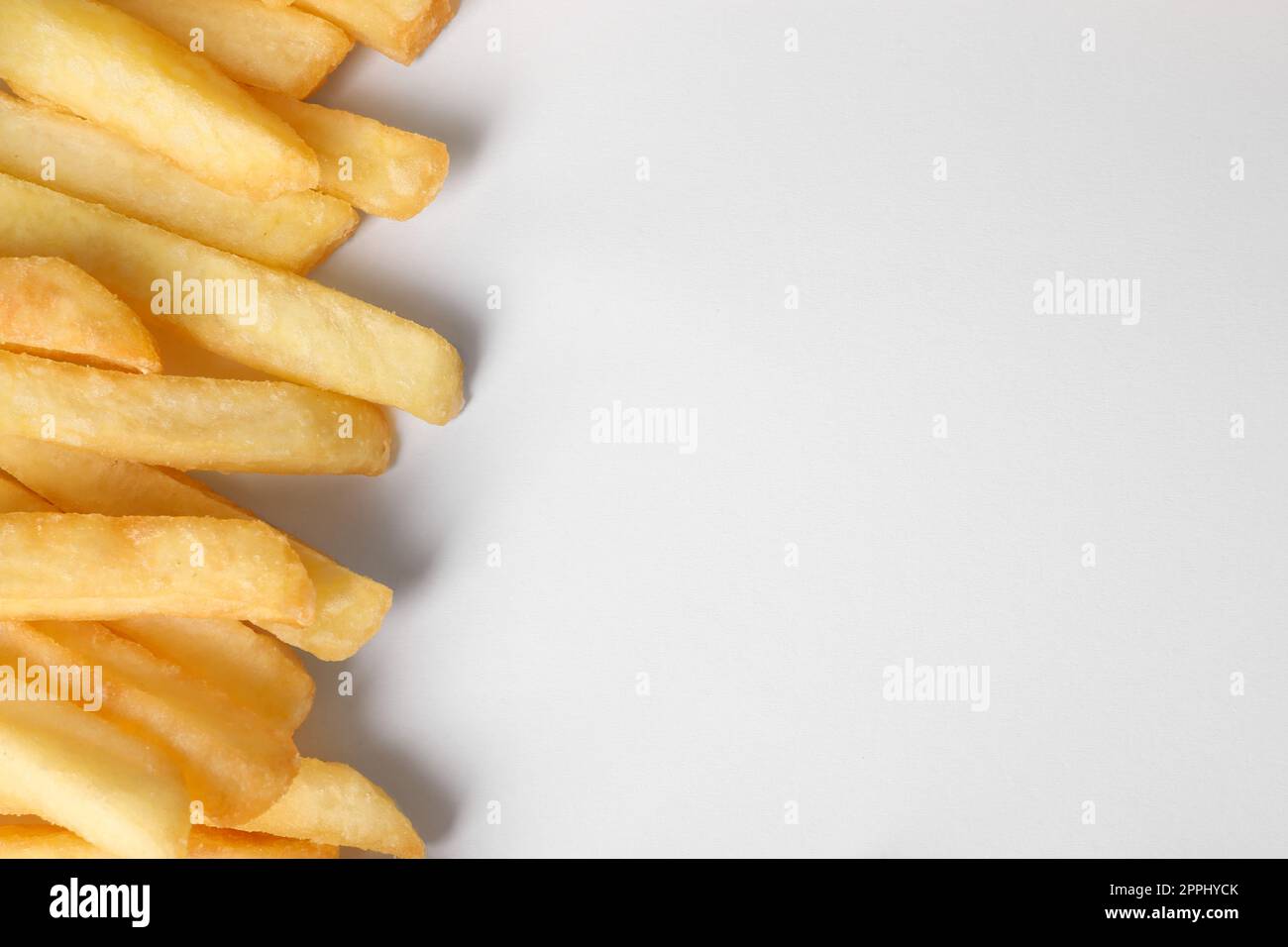 Delicious french fries on white background, flat lay. Space for text ...