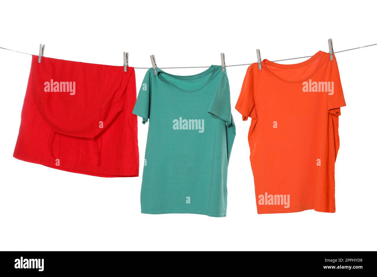 Different bright clothes drying on washing line against white ...