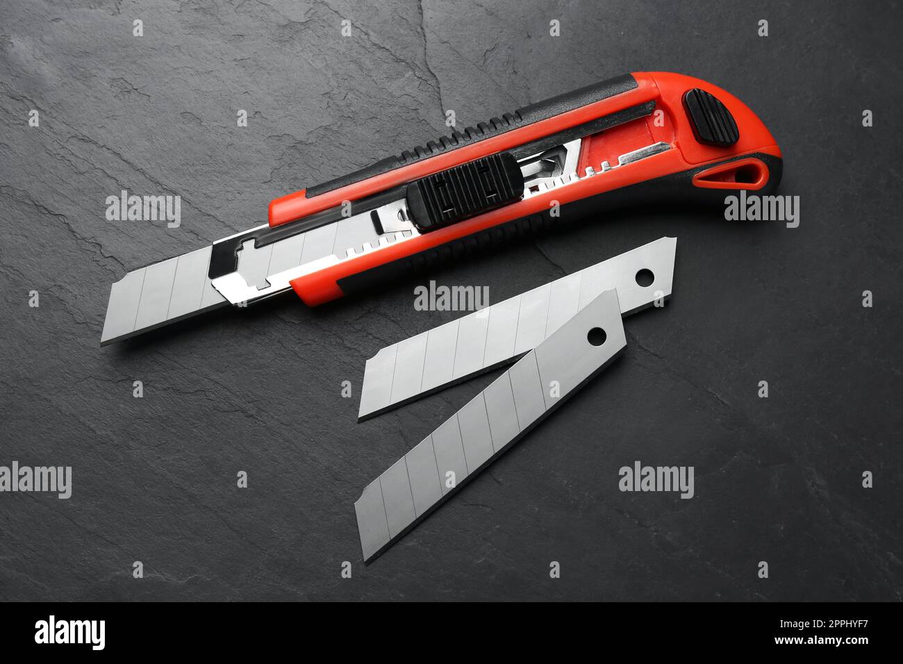 Utility knife and blades on black table, flat lay Stock Photo - Alamy