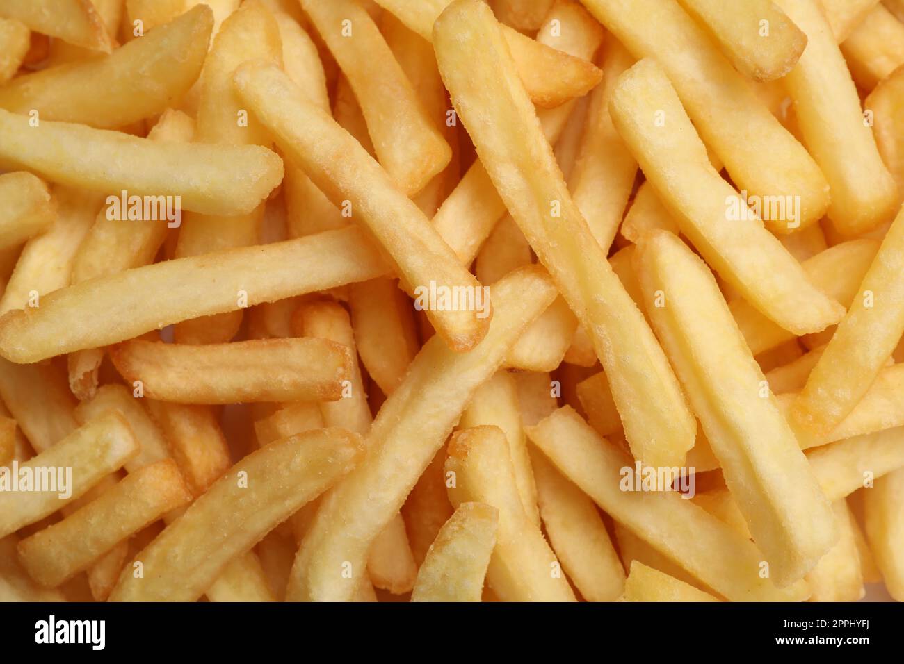 Many delicious French fry pieces as background Stock Photo - Alamy