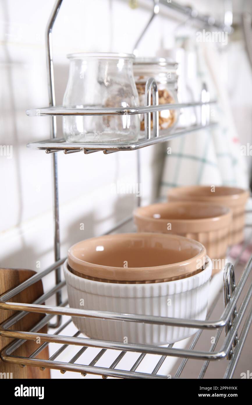 Many different ramekins on metal rack in kitchen Stock Photo - Alamy