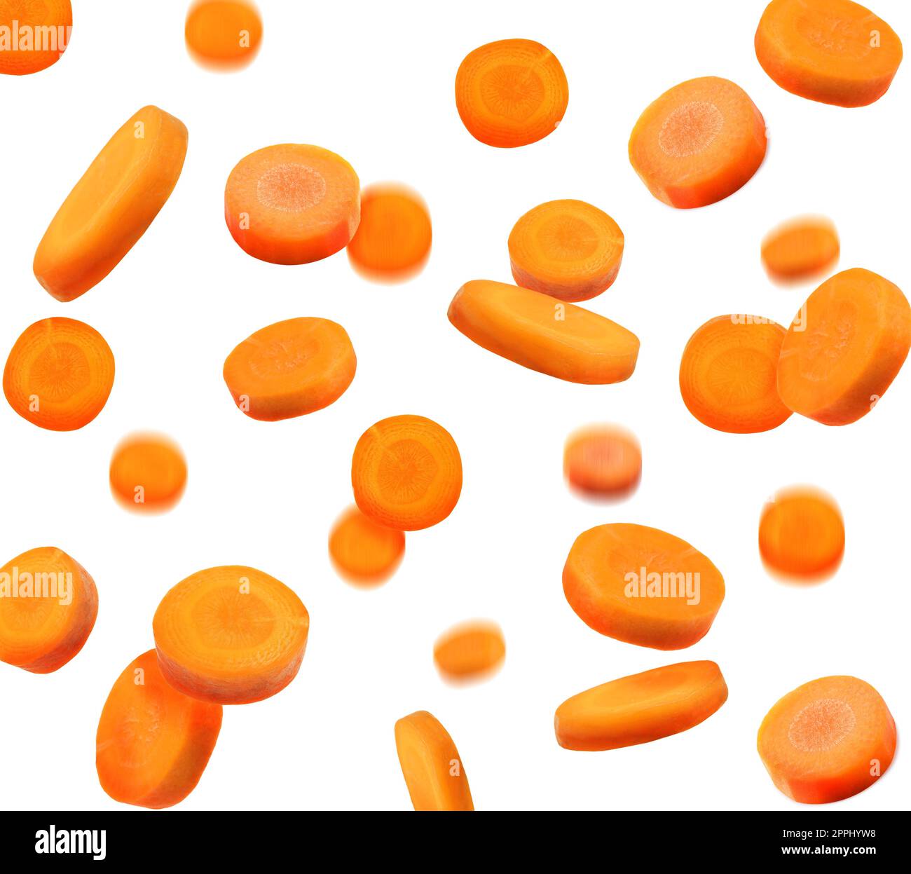 Slices of fresh carrots falling on white background Stock Photo - Alamy