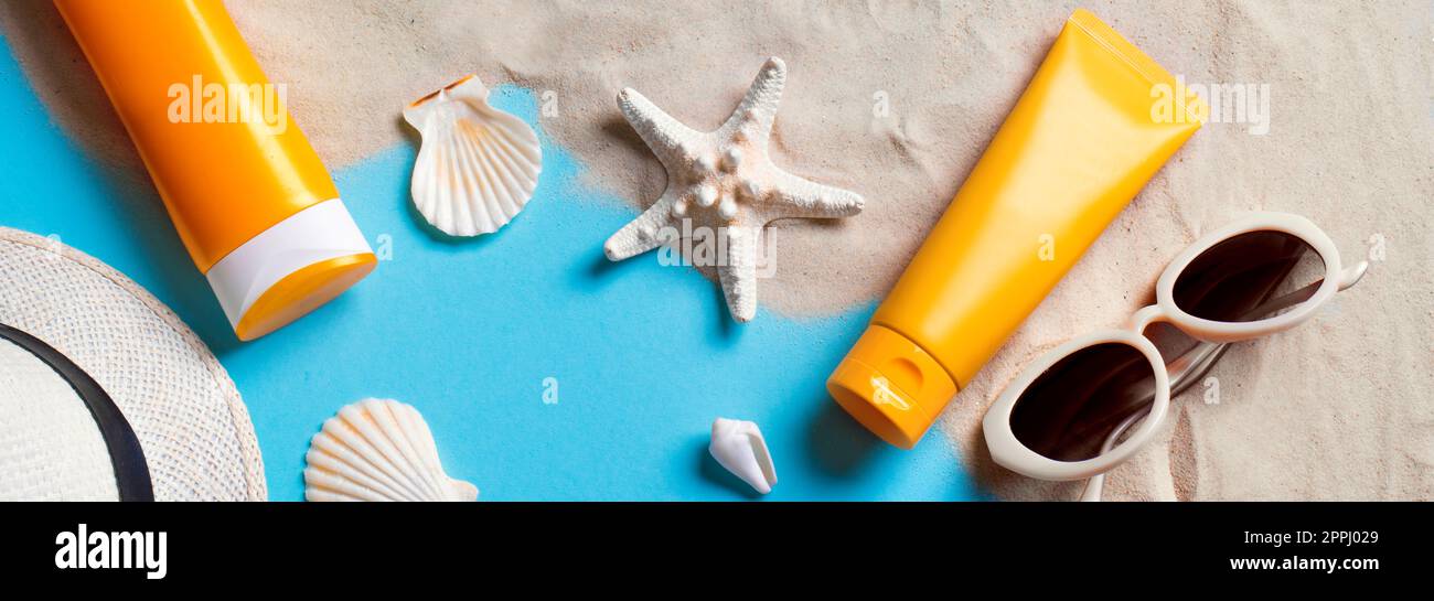 Summer composition with sunblock lotion bottles, starfish, sea shells ...