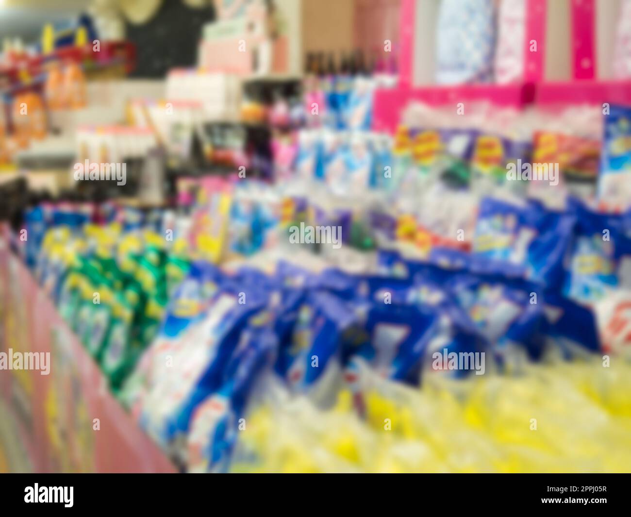 Blurred store shelves, washing powder and fabric softener section at a ...