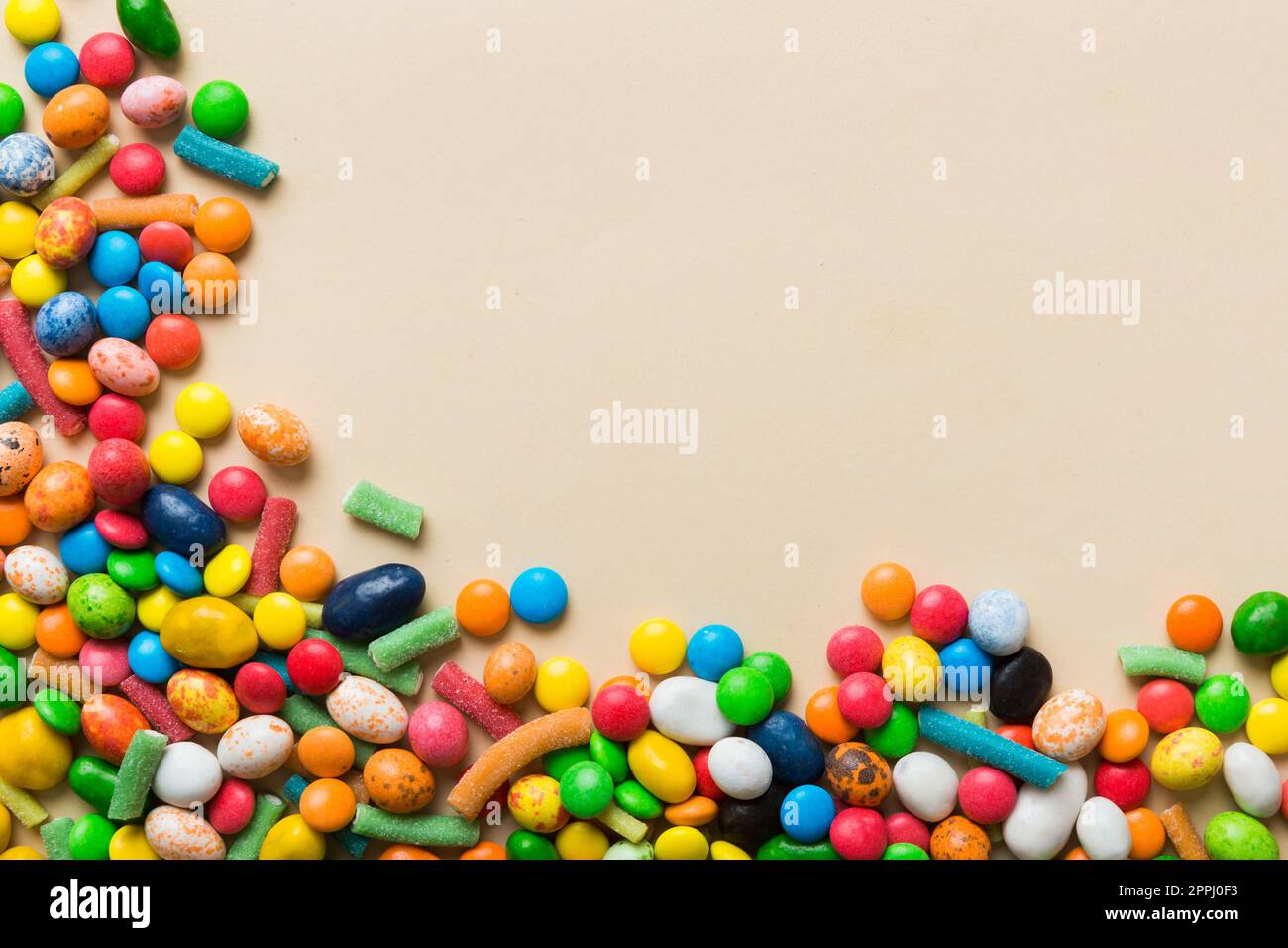 Mixed collection of colorful candy, on colored background. Flat lay ...