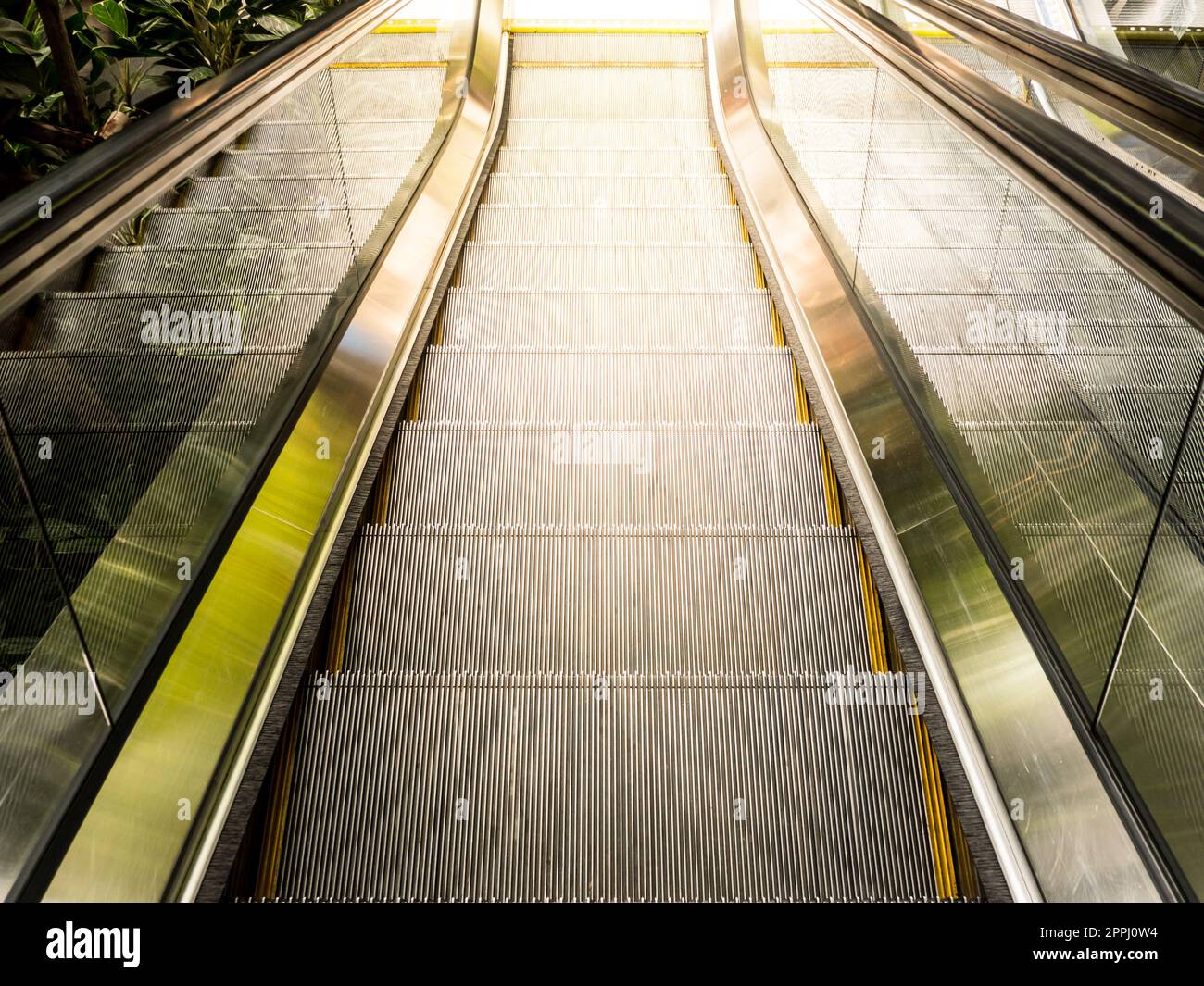Top view of escalators , sun light from outside Stock Photo - Alamy
