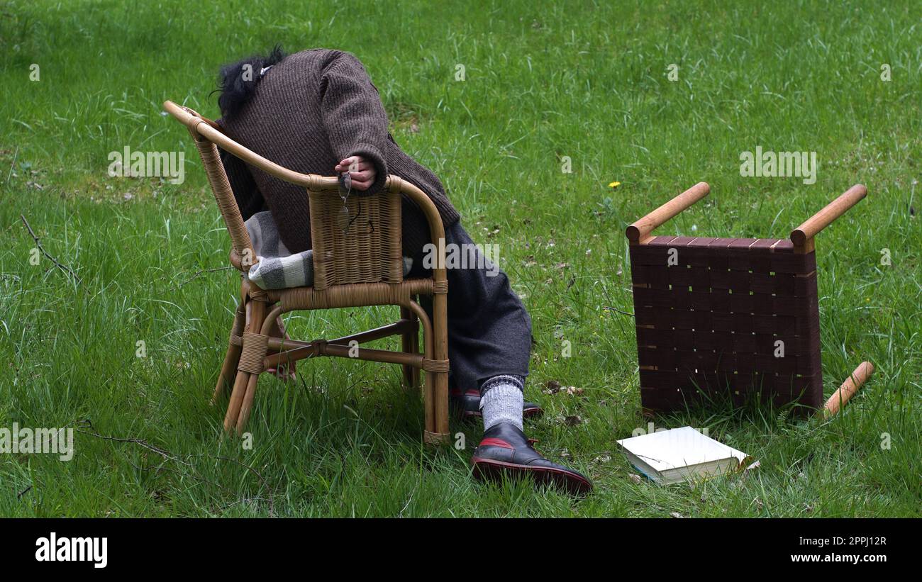 Woman almost falling off a chair, glasses in her hand. Either sick or ...