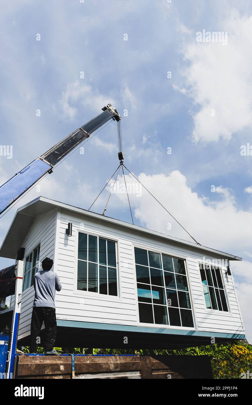 Crane lifting a knock down private house Stock Photo - Alamy