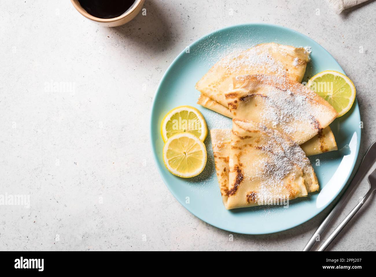 Citrus crepes Suzette with lemon on white background, copy space ...