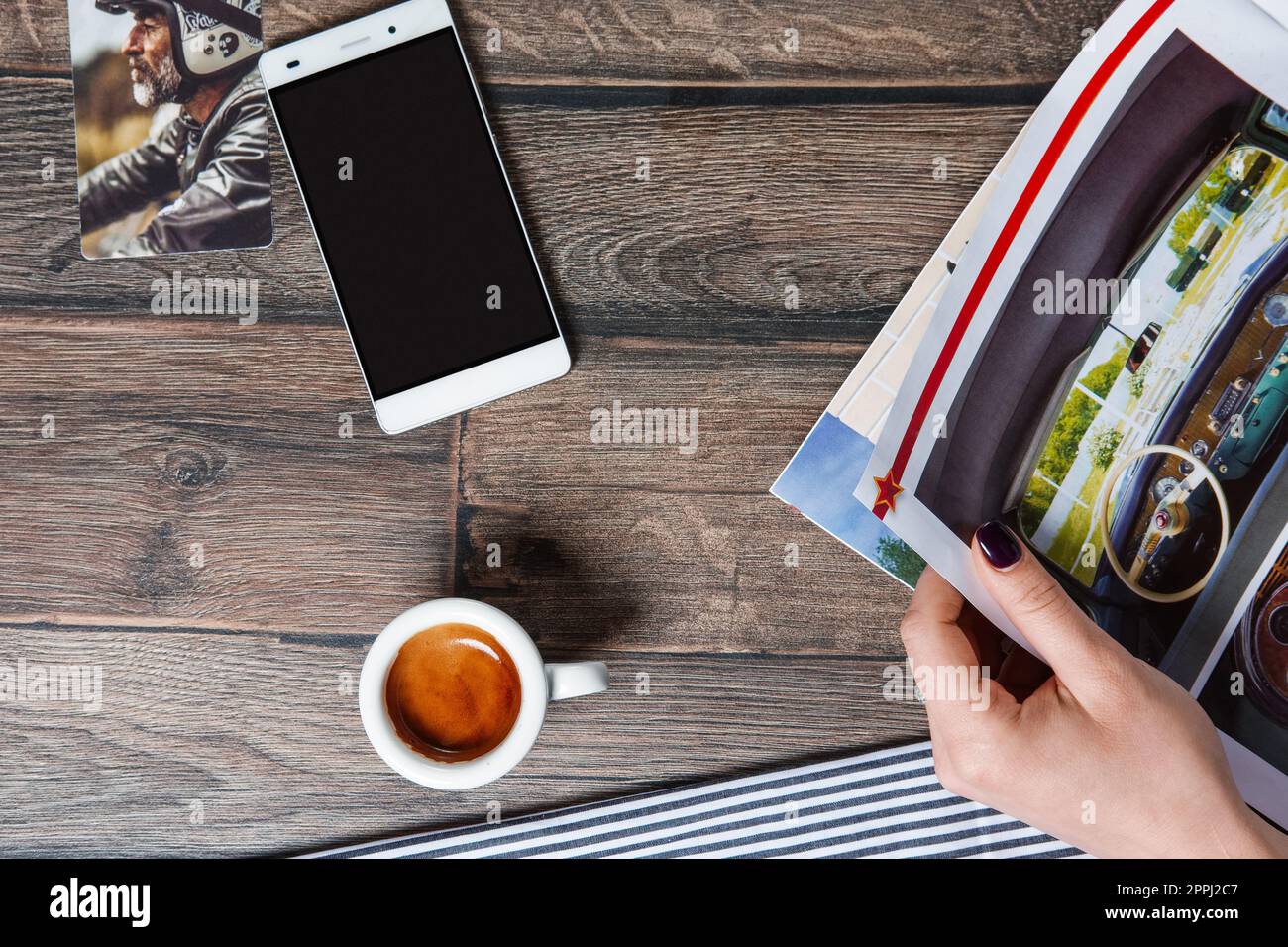 Top view of table with cup of coffe and smartphone. Hand holding ...