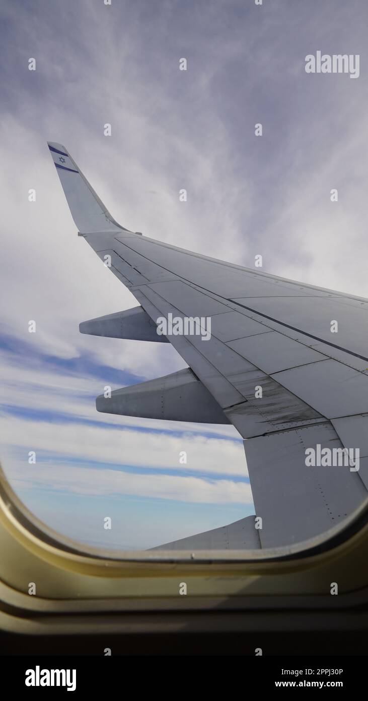 Wing of an airplane, passenger s view. Looking through the window of a ...