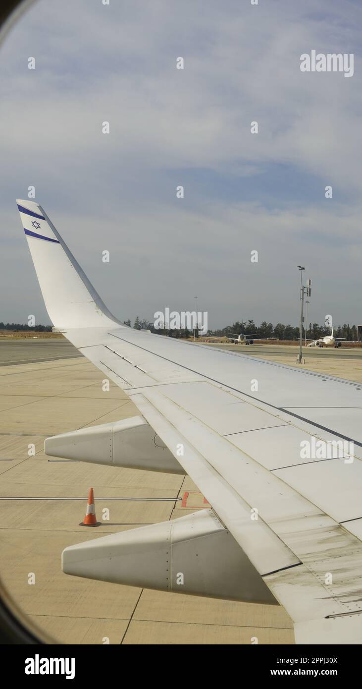 Wing of an airplane, passenger s view. Looking through the window of a ...