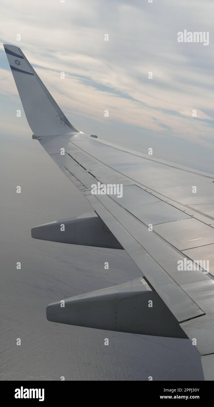 Wing of an airplane, passenger s view. Looking through the window of a ...