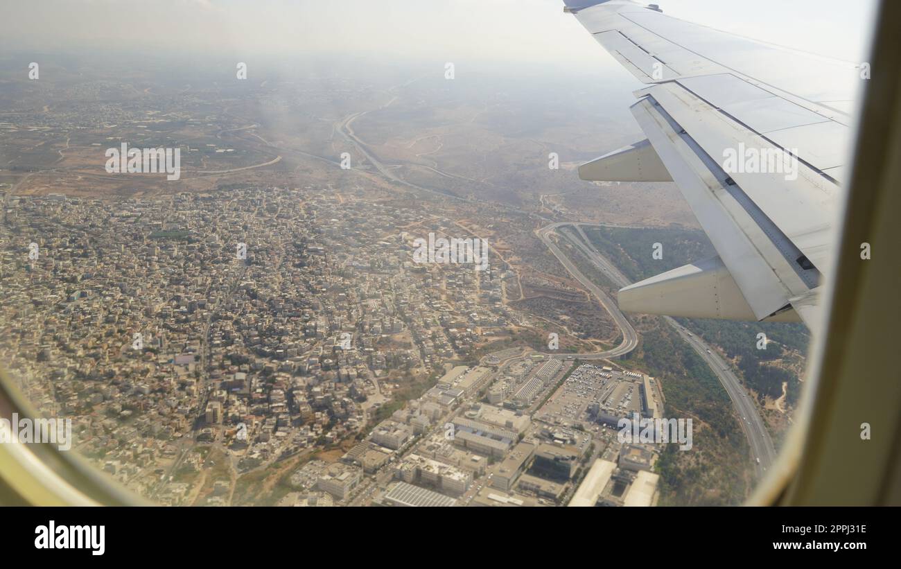 Wing of an airplane flying over Israel, Passenger s view. Looking ...