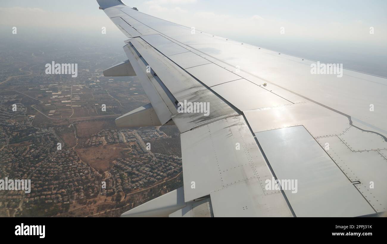 Wing of an airplane flying over Israel, Passenger s view. Looking ...