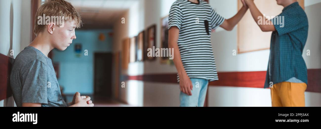 Two young boys say hello to each other at the school corridor Stock ...
