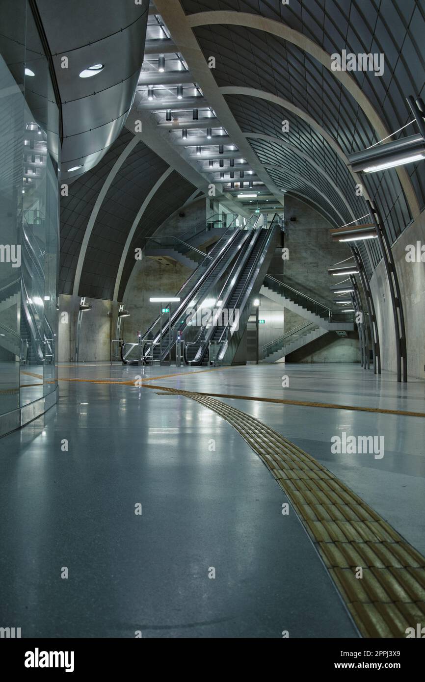 Futuristic subway station with guiding lines and an escalator near ...