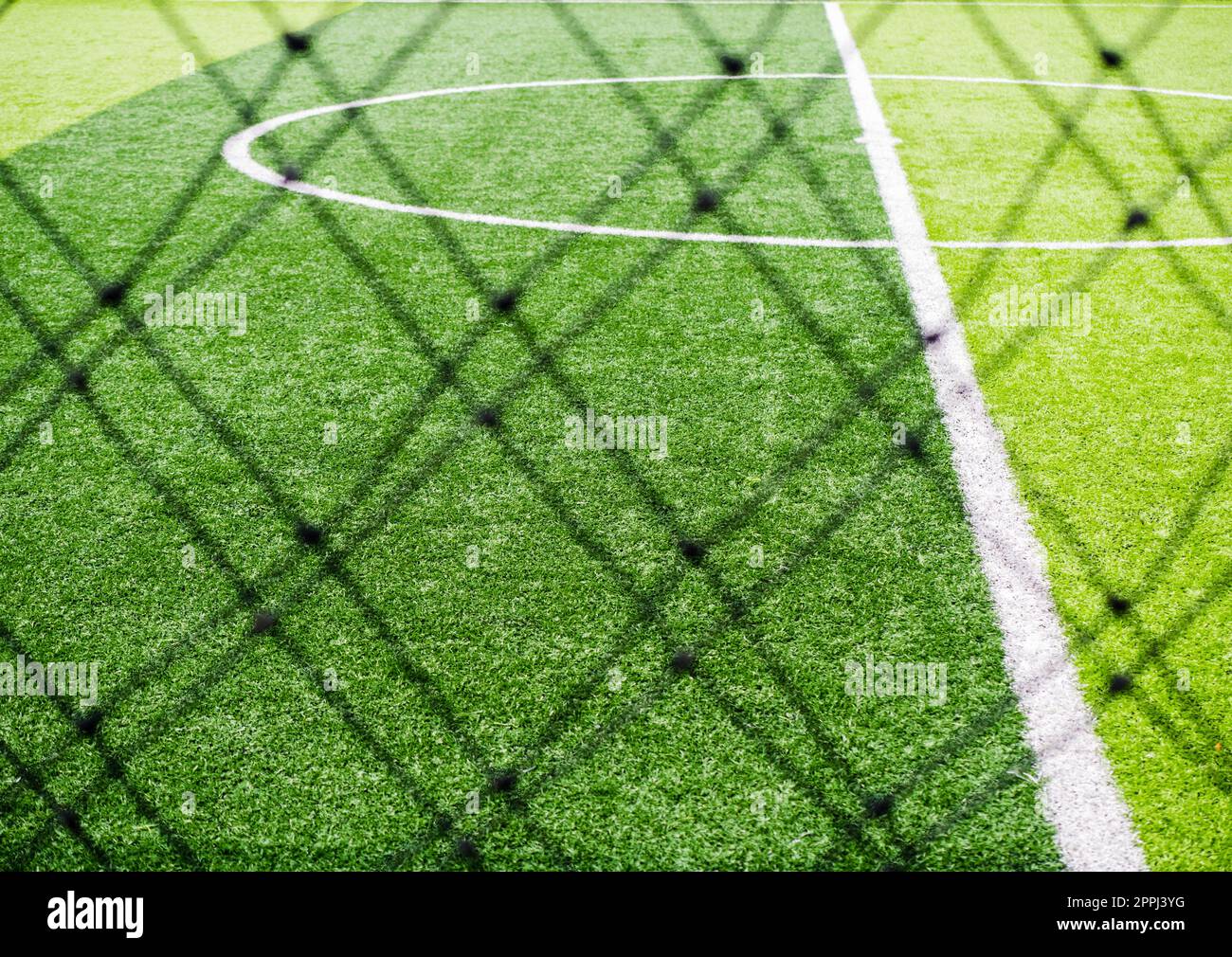 Soccer field, corner side, made from synthetic lawn, behind the net ...