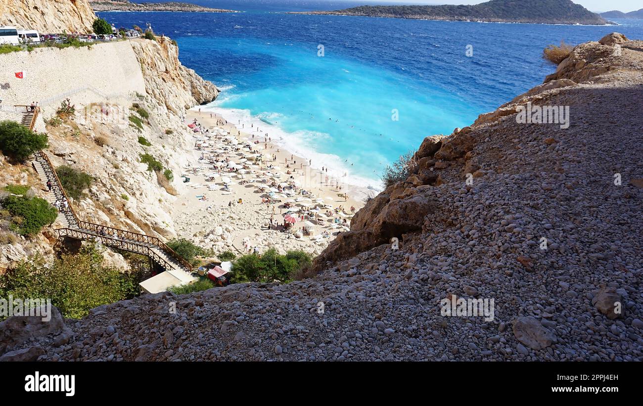 Aerial view from road of people crowd relaxing on beach. Swimming ...