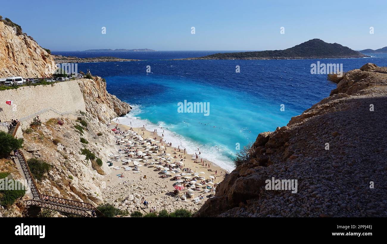 Aerial view from road of people crowd relaxing on beach. Swimming ...