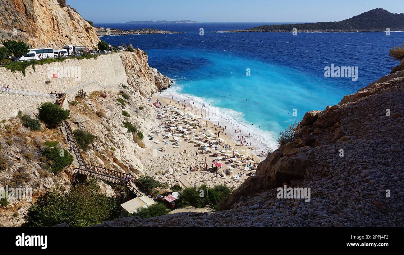 Aerial view from road of people crowd relaxing on beach. Swimming ...