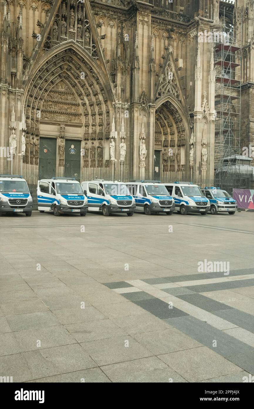 Row of Mercedes-Benz Sprinter police cars in front of Cologne Cathedral ...