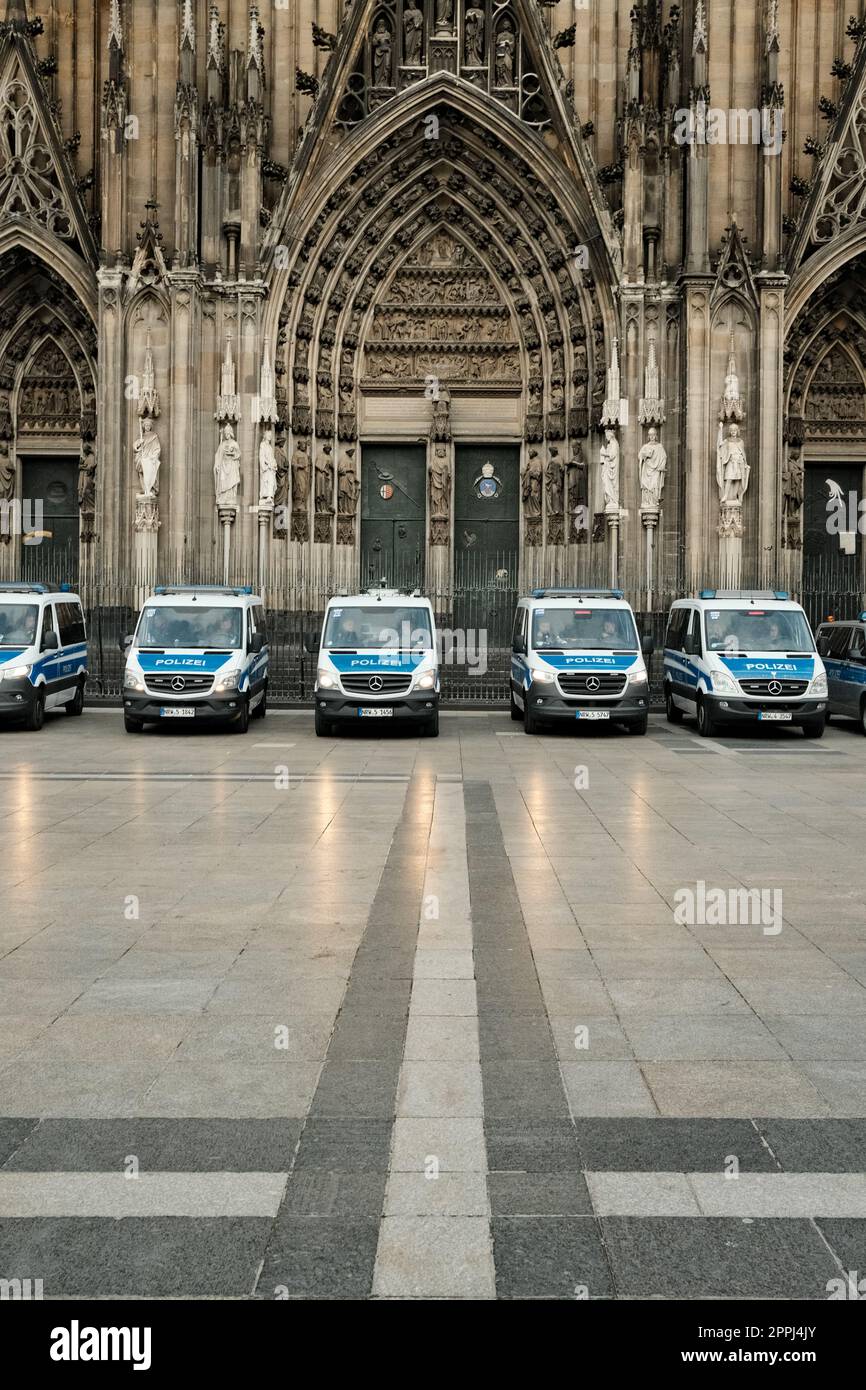 Row of Mercedes-Benz Sprinter police cars in front of Cologne Cathedral ...
