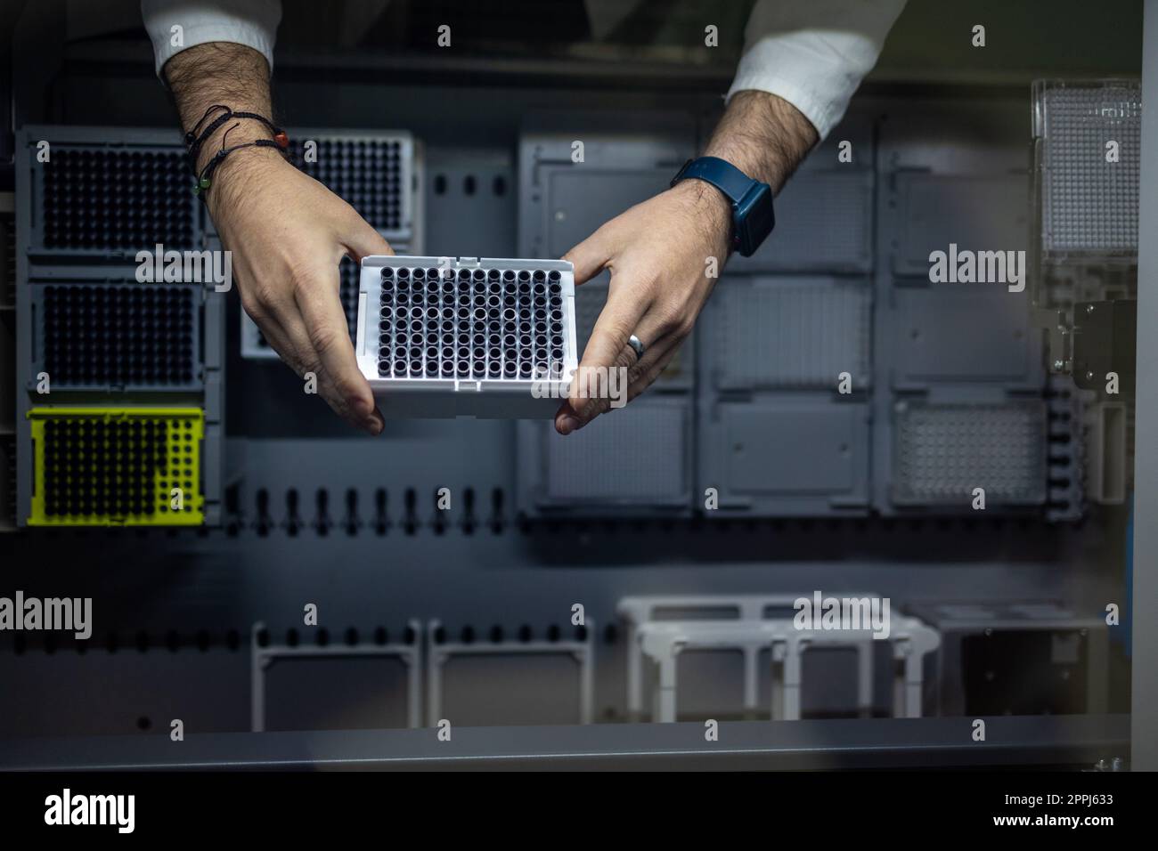 Hands of a researcher carrying out research experiment in a chemistry ...