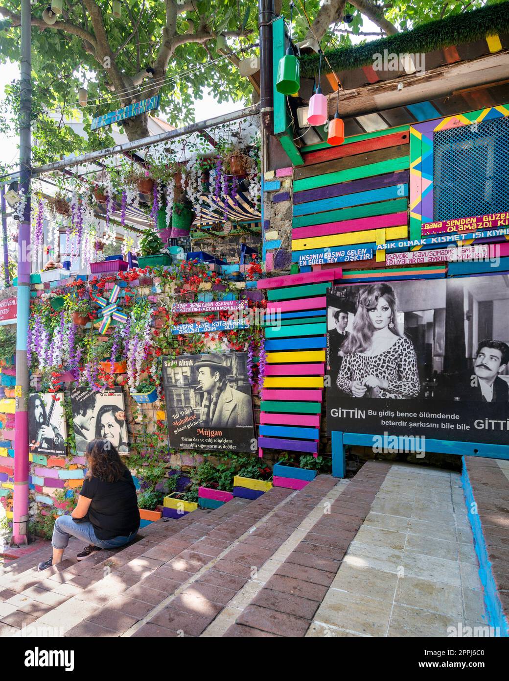 Daytime shot of cafe decorated with multicolored panels, movie poster ...
