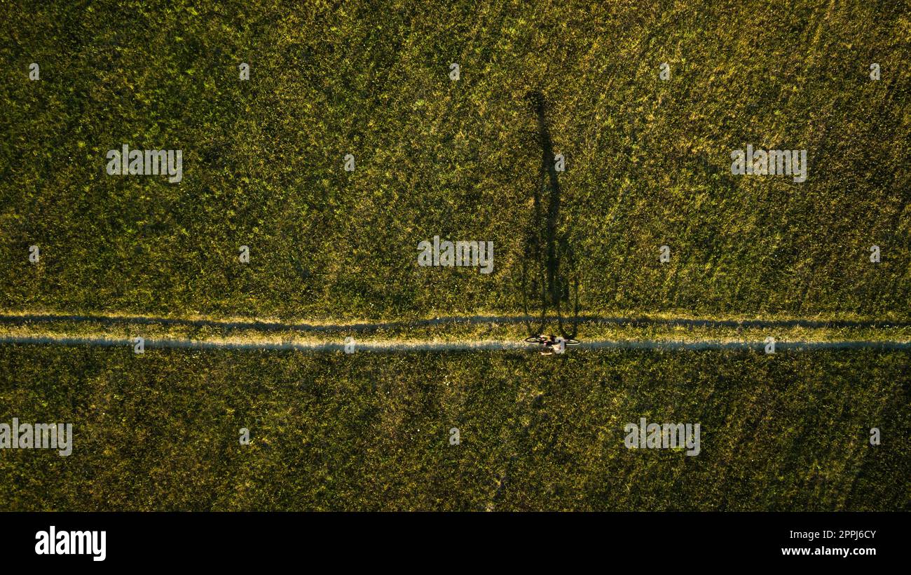 Aerial image of a biker on a mountain bike amid fields outdoors Stock ...